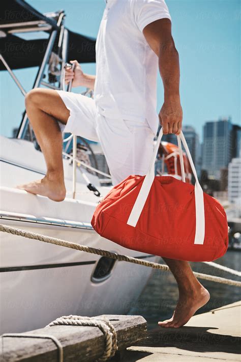 Male Boarding Boat With Bag By Stocksy Contributor Waa Stocksy