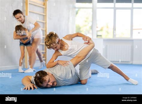 Father Teaches His Son To Use Forceful Techniques And Grips During Self