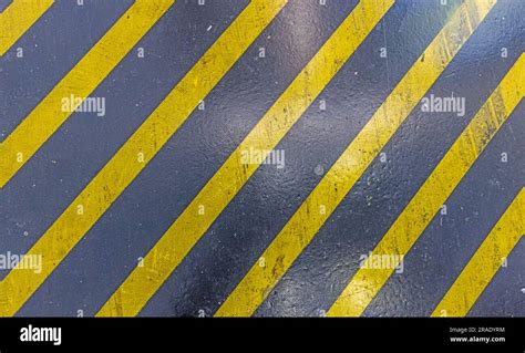 Vertical Shot On A Black Ground Surface With Yellow Hatching As A