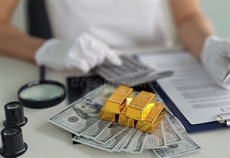 Gold Bars And Cash On Table During Financial Transaction At