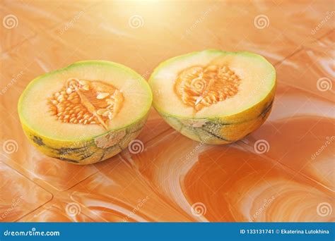 Orange Cut Melon With Seeds Inside Two Halves Of A Beautiful Me Stock