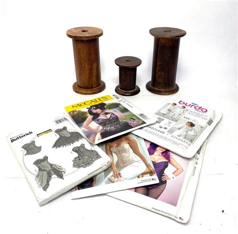 Lot Three Timber Bobbins And A Small Collection Of Dress Pattern