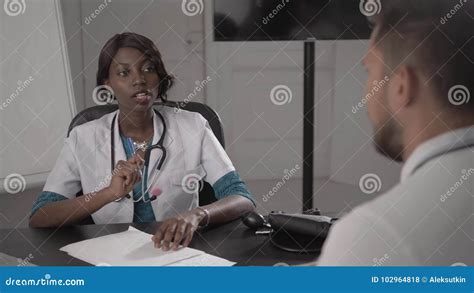 Doctor In White Coat Examining Male Patient In Office Blood Pressure
