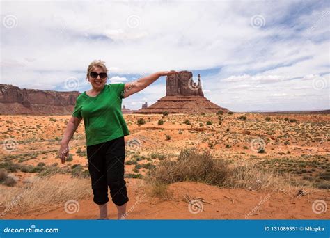 Forced Perspective View Of A Pretty Female Appearing To Be Holding