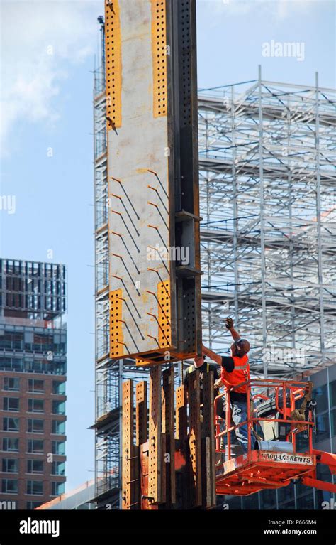 Steel Column Being Moved Into Position Over Another Steel Column At