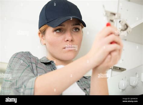Woman Assembling A White Shelf Stock Photo Alamy