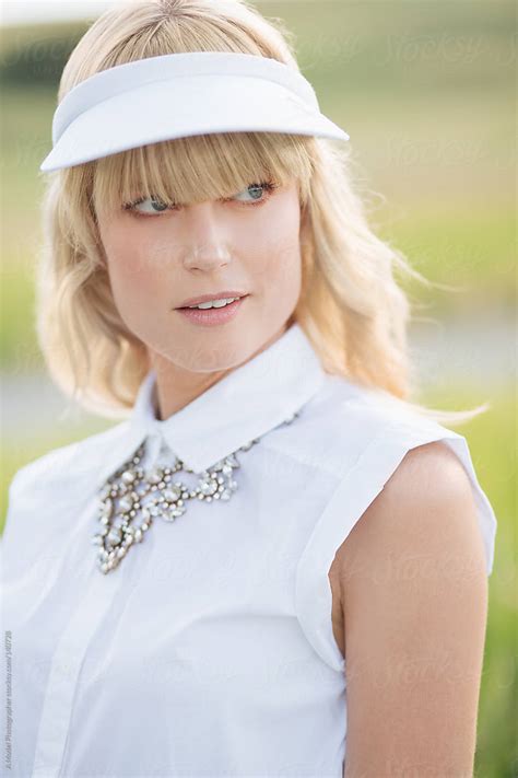 A Woman Wearing A Sporty Visor Ready For A Game By Stocksy