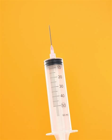 Premium Photo Large Plastic Medical Syringe With A Long Needle For
