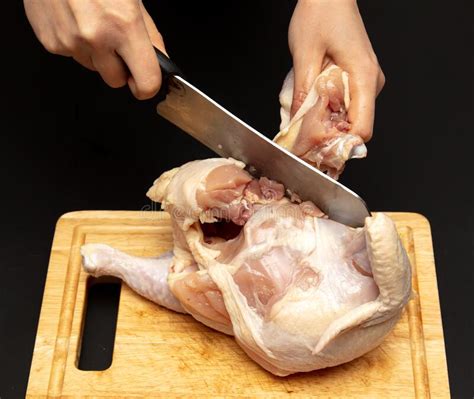 Cutting Chicken Carcass On A Board On A Black Background Stock Image