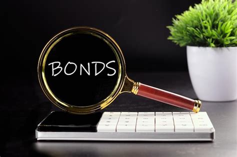 Premium Photo Bonds Text Seen With A Magnifying Glass On A Black Background