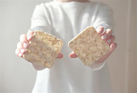 Premium Photo Girl Holding Puffed Rice Bread Crushed Diet Crispy