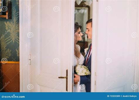 Loving Newlywed Bride And Groom Closing The Doors While Kissing Stock