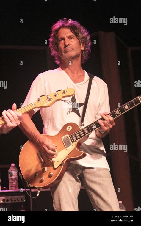 Musician Billy Squier Is Shown Performing On Stage During A Live