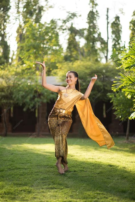 Premium Photo Woman Dancing On Grass Against Trees