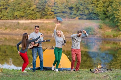 Premium Photo Group Of Happy Friends With Guitar Having Fun Outdoor