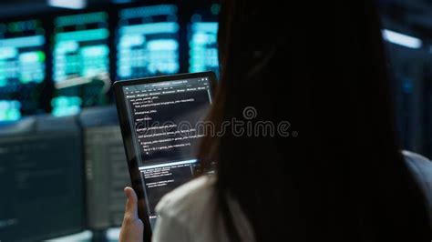 Close Up Of Woman Doing Maintenance In Server Room Using Tablet Stock