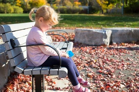 Premium Photo Girl Sitting On Bench In Park