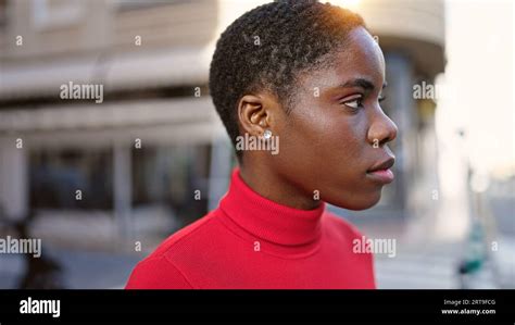 African American Woman Standing With Serious Expression At Street Stock