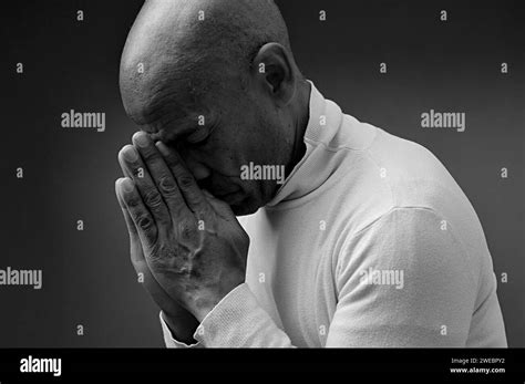 Black Man Praying To God With Hands Together Caribbean Man Praying With