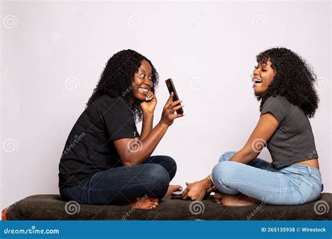 Lady Showing Her Friend Something On Her Phone Stock Photo Image Of Showing Friend 265135938