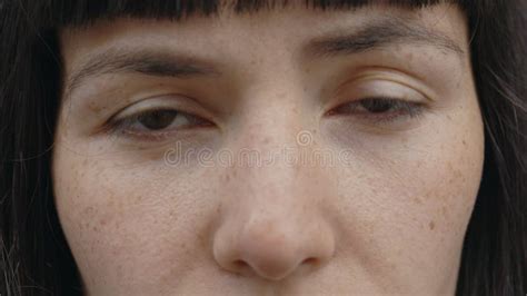 Close Up Of Woman S Face As She Opens Her Brown Eyes And Looks Focused
