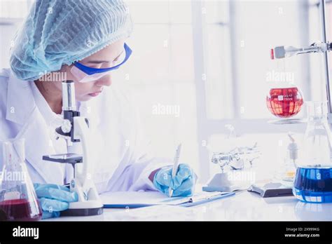 Female Scientist Look At Microscope Science Test Tube Analyse