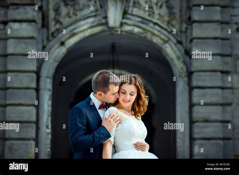 Half Length Portrait Of The Groom Gently Hugging The Ginger Head