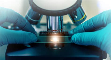 Close Up Of Scientist Hands With Microscope In Medical Research Lab Or Science Laboratory Stock