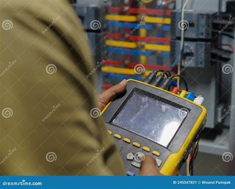 Electrical Engineers Test The Voltage And Current Of The Wires In The Electrical Cabinet Control