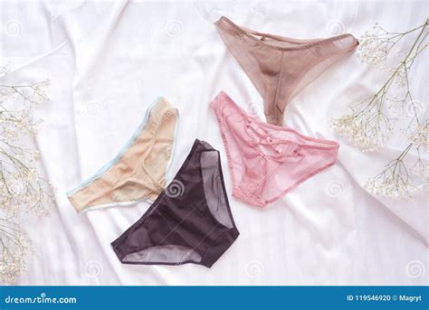 Fashion Trendy Lace Lingerie Different Panties On White Bed Background