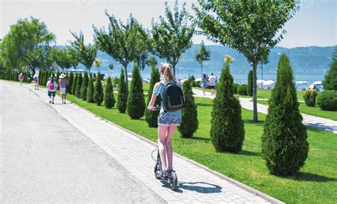 Back View Of A Female Riding Electric Scooter Stock Photo At Vecteezy