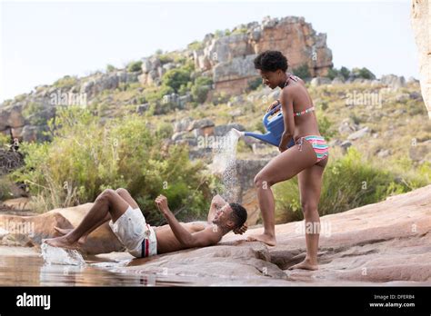 Woman Splashing Water On Babefriend At Lakeside Stock Photo Alamy