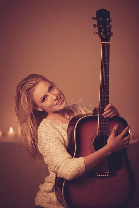 Young Blonde Woman Playing Guitar In Candle Light Stock Image Image