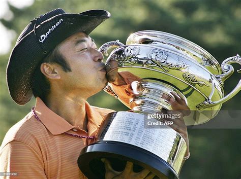 Japanese Golfer Shingo Katayama Kisses The Champions Trophy During An