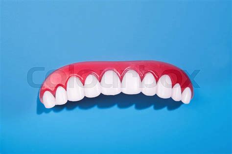 One Model Denture Teeth Prosthesis On A Blue Background Top Colourbox