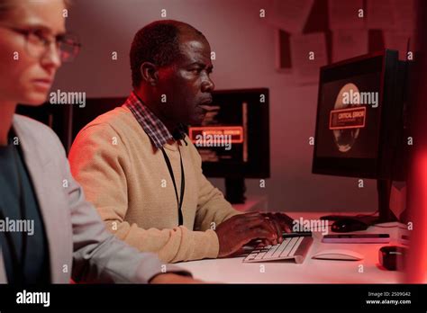 Mature African American Male It Manager Typing On Computer Keypad While