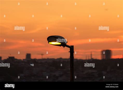 Street Lamp Against Beautiful Sunset Sky Colorful Clouds And City