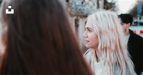 긴 금발 머리를 한 여자가 한 무리의 사람들 앞에 서 있다 사진 Unsplash의 무료 여성 이미지