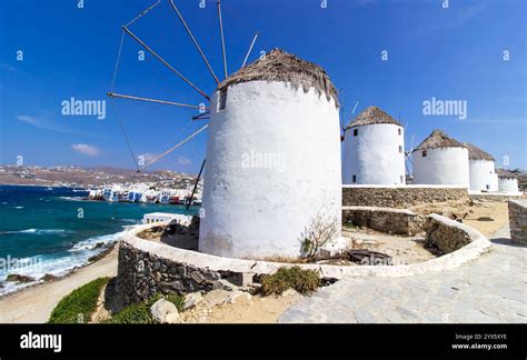 Traditional Greek Windmills On Mykonos Island Under Cloudy Sky Aerial