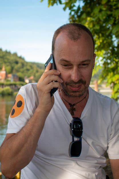 Premium Photo Portrait Of Man Holding Mobile Phone