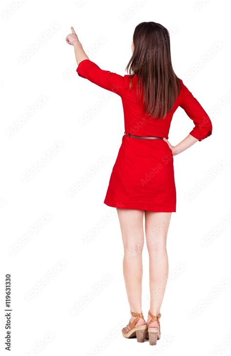 Back View Of Young Brunette Woman Pointing At Wall Beautiful Girl In