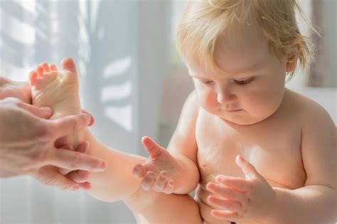 Premium Photo Mom Gives Her Baby A Leg And Foot Massage Close Up