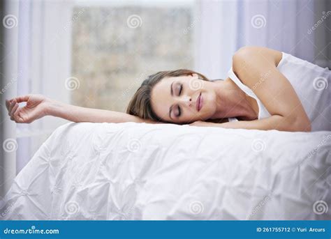 Shes A Dreamer A Beautiful Woman Sleeping Peacefully On Her Bed Stock