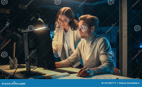 Software Developer Working On Desktop Computer In The Evening In Office