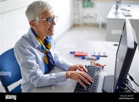 A Female Professor In Front Of A Computer Desk At The Informatics Lecture In The University