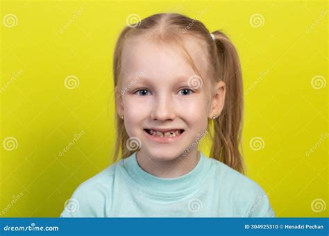 Portrait Of A Smiling Seven Year Old Girl With Growing Molars And
