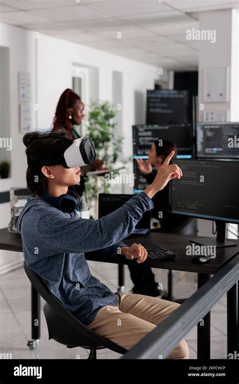 Software Developer Wearing Virtual Reality Headset Working To Develop Security Program In It