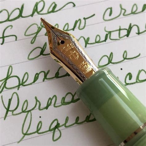 Green Fountain Pen On Paper With Cursive Writing