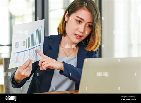 A Female Executive With A Data Graph Having Online Meeting Young Woman