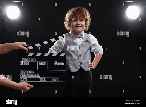 Smiling Cute Boy Performing While Second Assistant Camera Holding